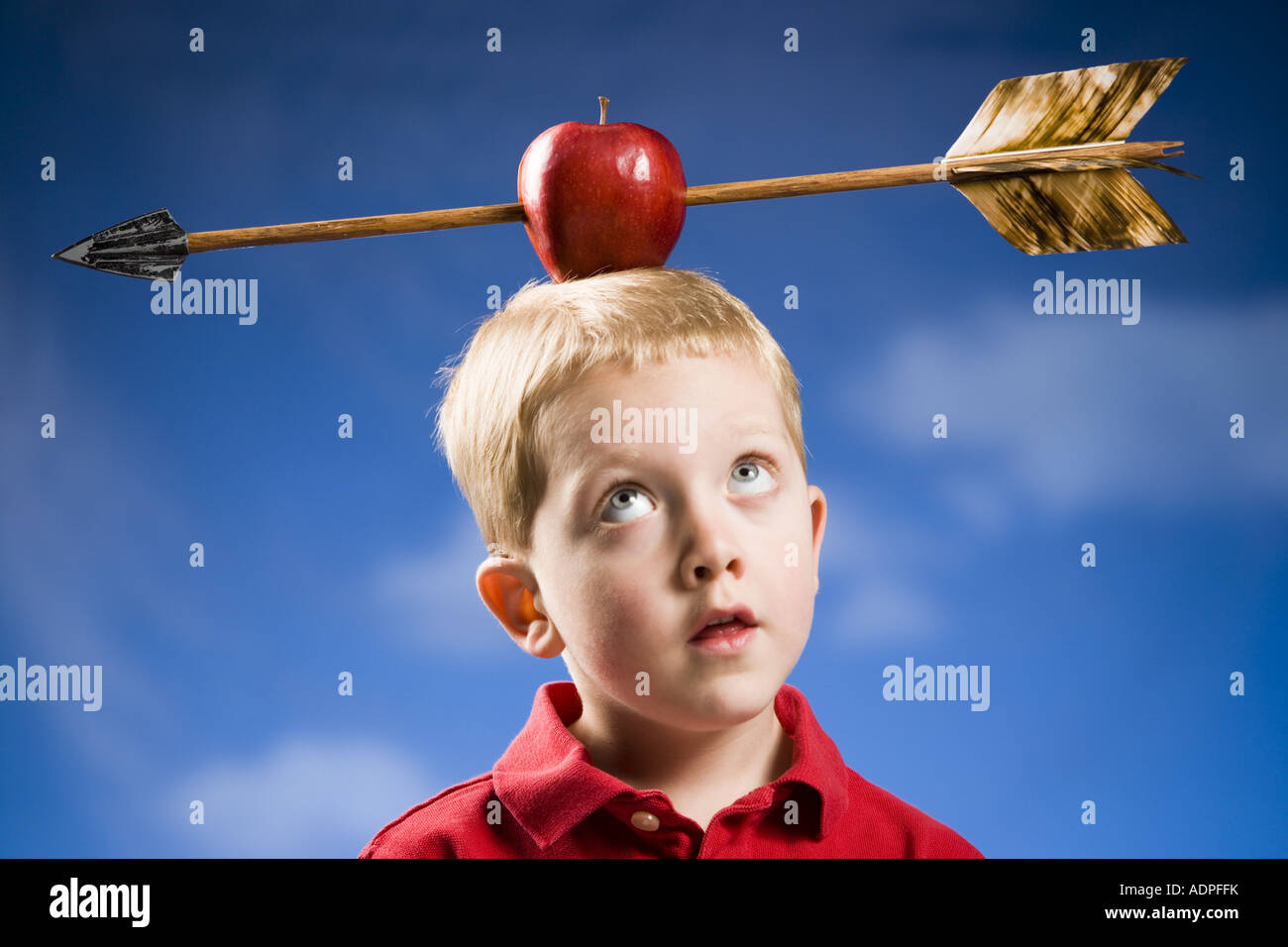 Boy with apple and arrow on head Stock Photo - Alamy