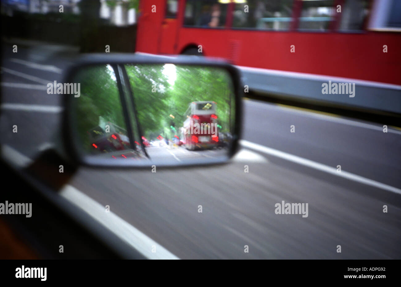 Car passing red bus at speed Stock Photo - Alamy
