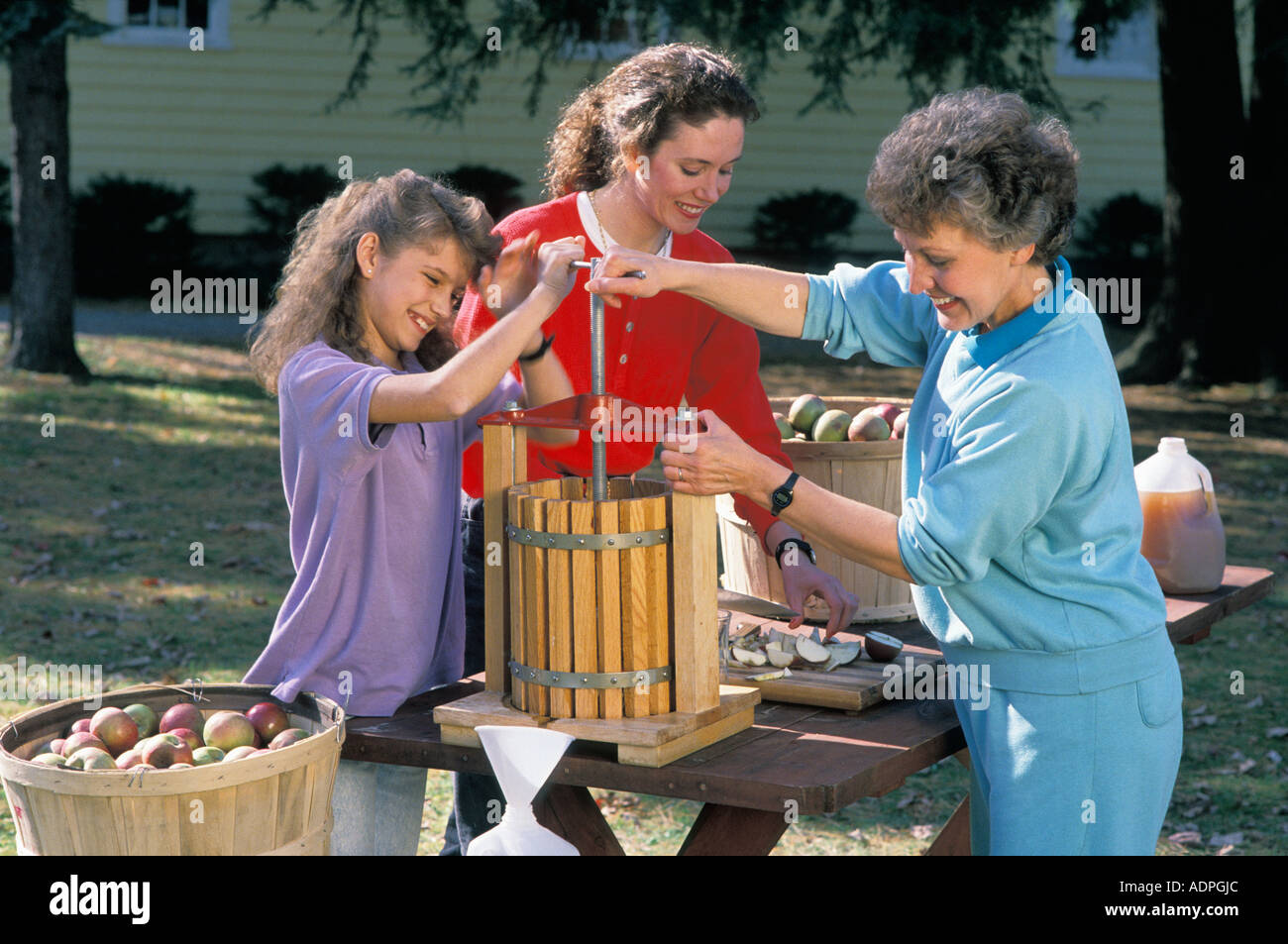 Three generations of caucasian women making apple cider Stock Photo - Alamy