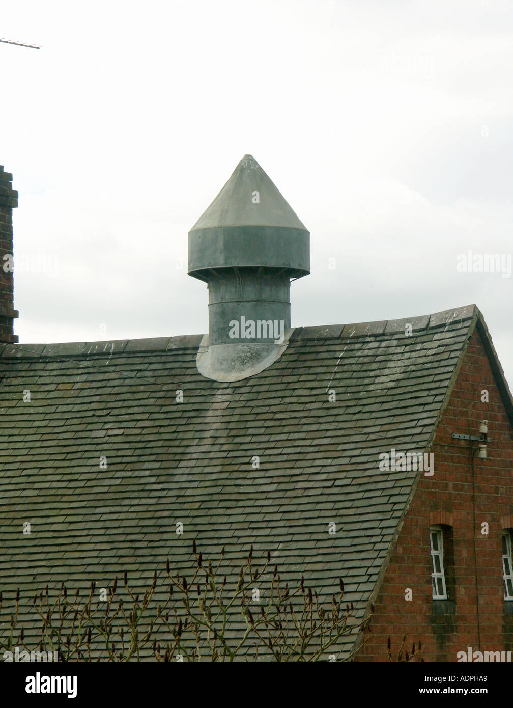 A large cylindrical metal vent on a tiled rooftop Stock Photo - Alamy