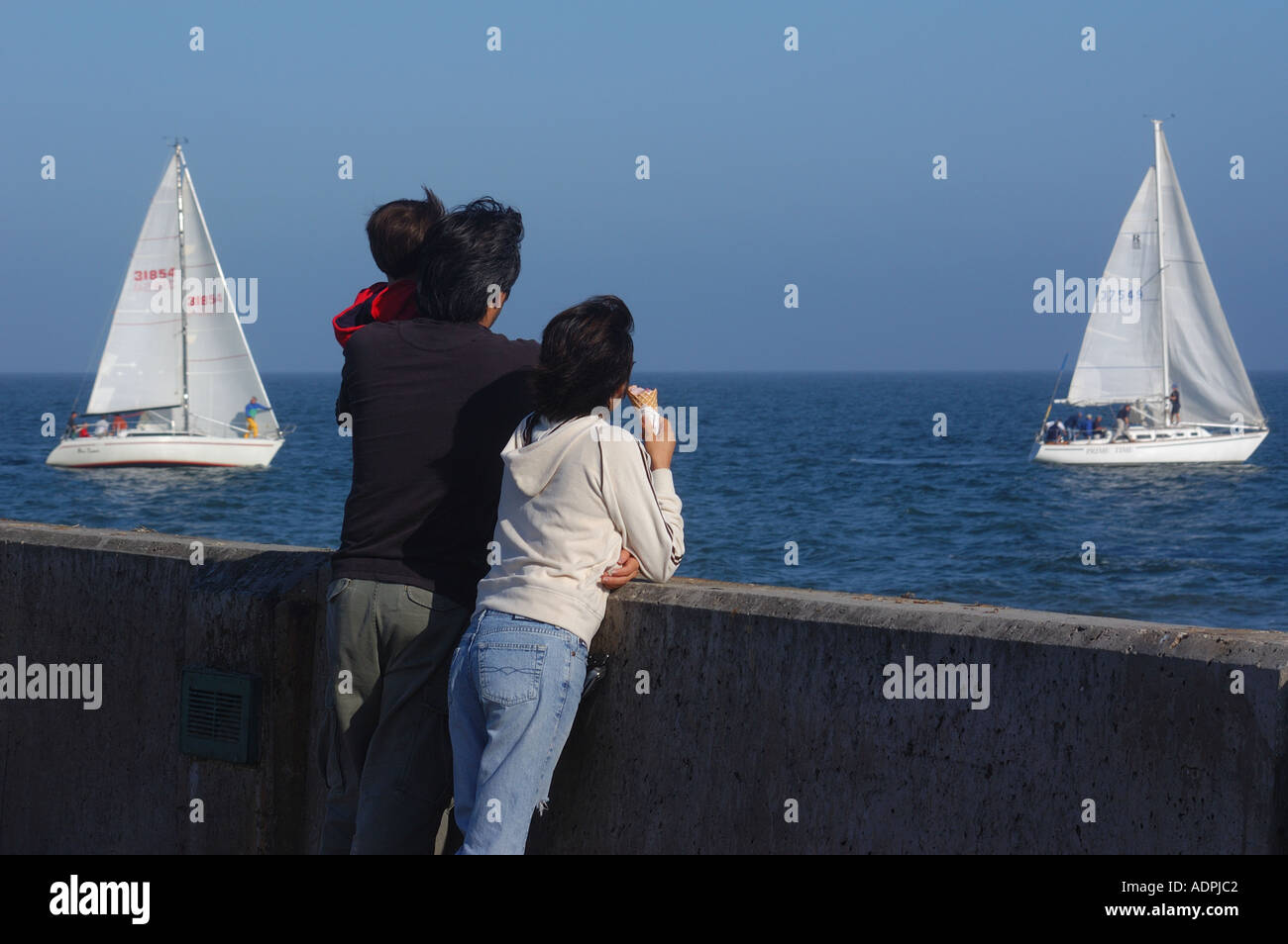 Family Watching Sailboats Stock Photo - Alamy