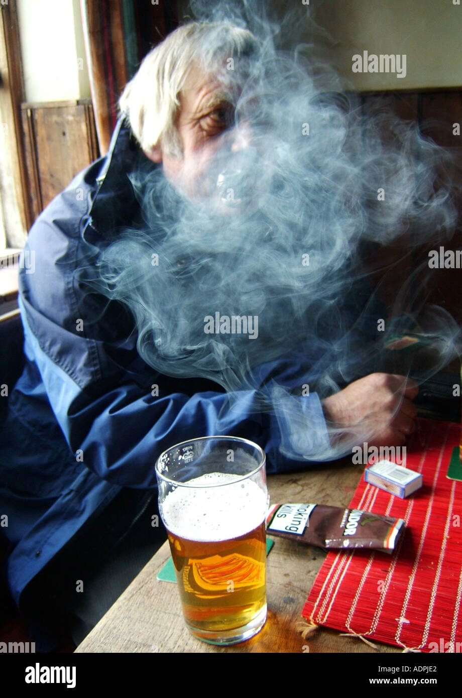 man puffing on pipe Stock Photo - Alamy