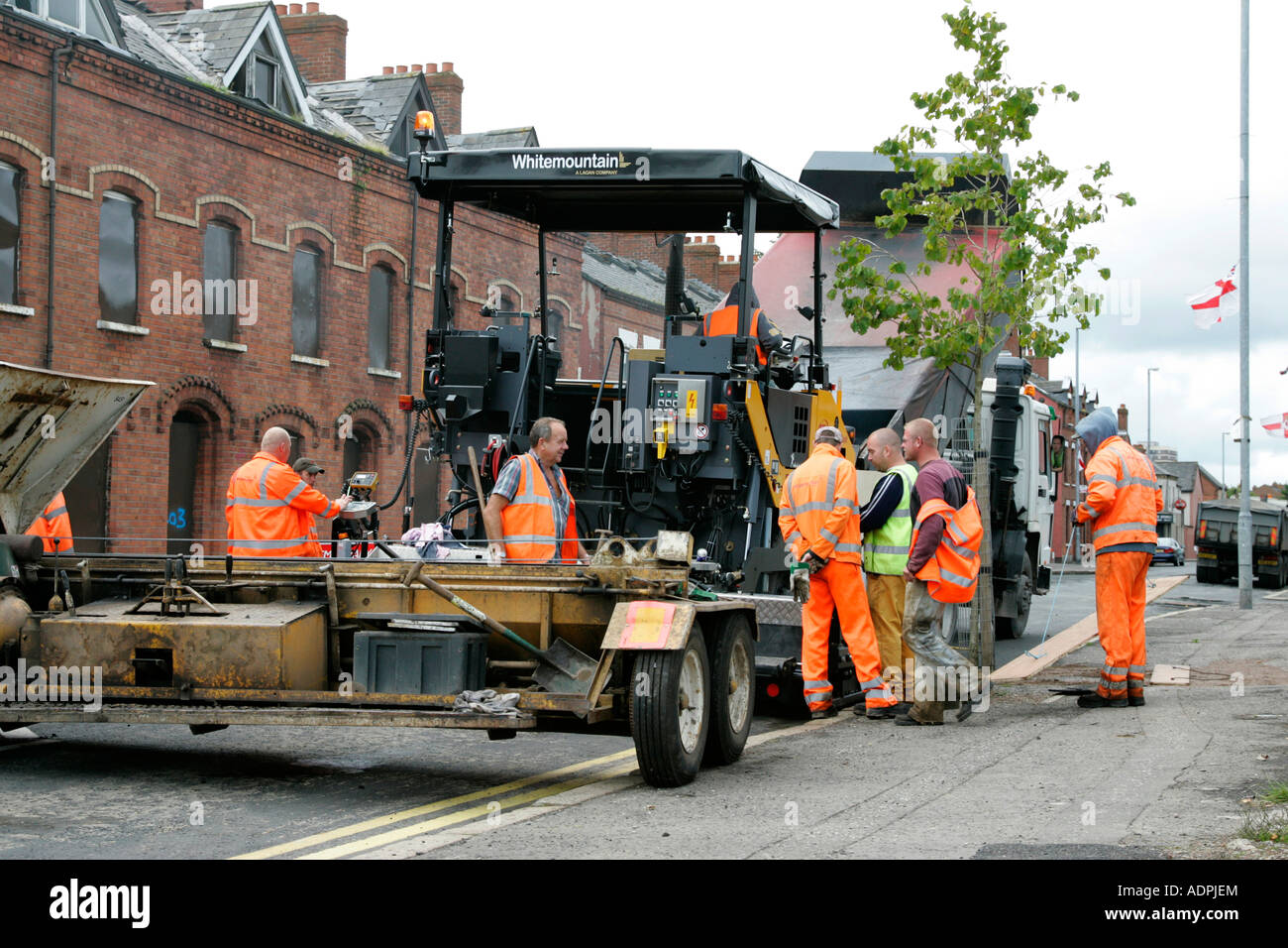 road resurfacing crew prepare equipment to resurface tarmac road in ...
