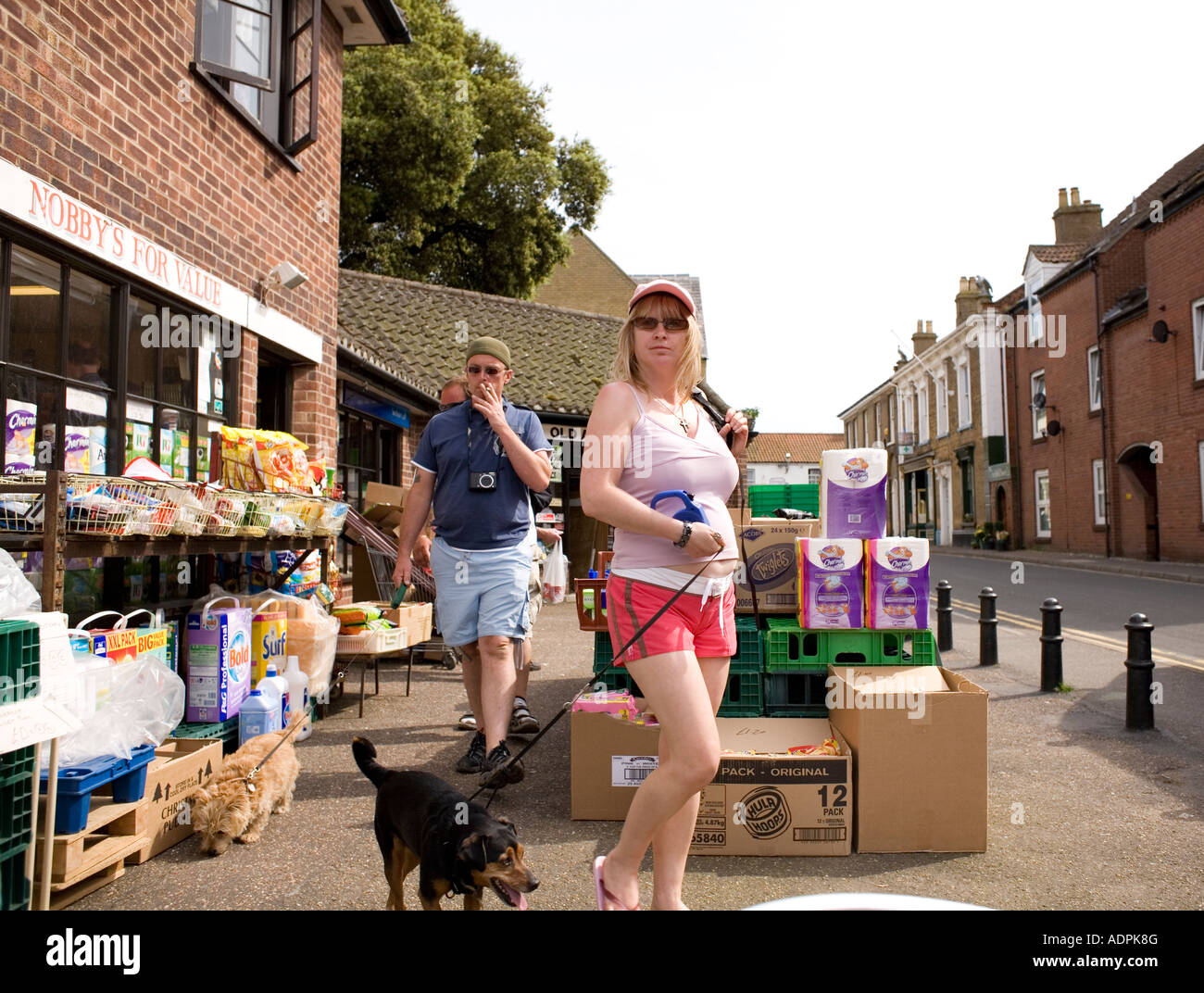 two holiday-makers and their dogs go shopping Stock Photo - Alamy