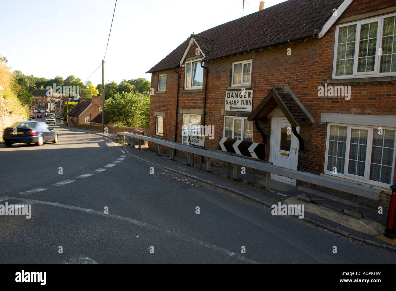 Danger Sharp Turn sign on wall of house Potterne Wiltshire UK Stock ...