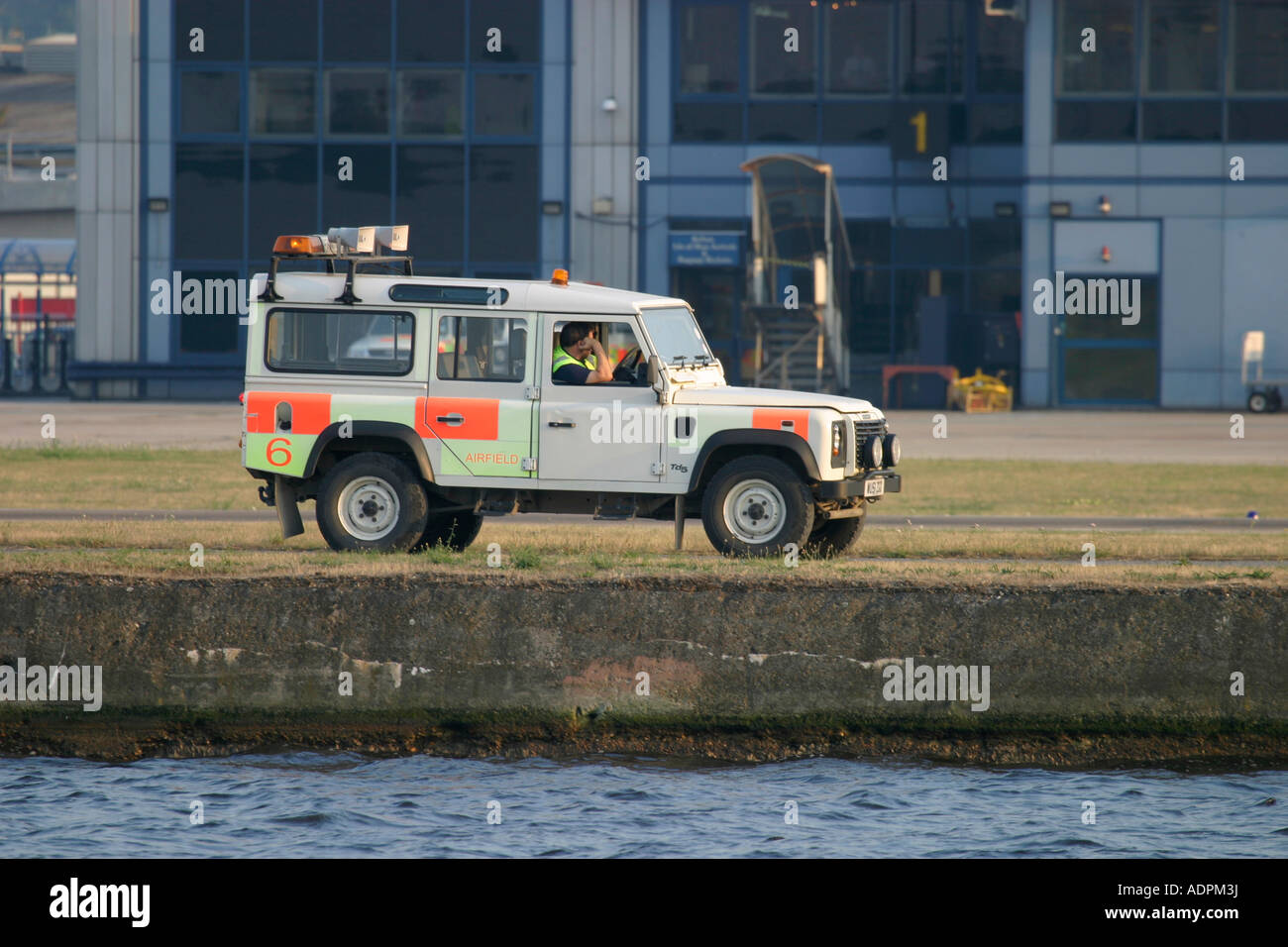 Airport worker in Land Rover. London City Airport, England, UK Stock ...