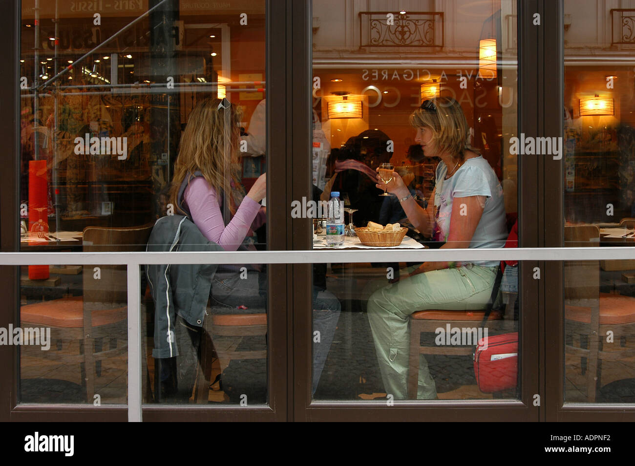 Two women dining in window of restaurant in Paris France Stock Photo ...