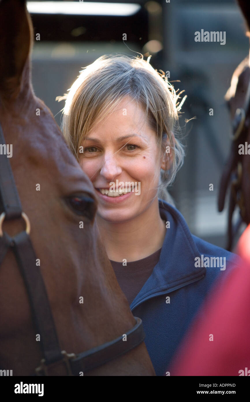 Woman in stable at horse show Stock Photo - Alamy