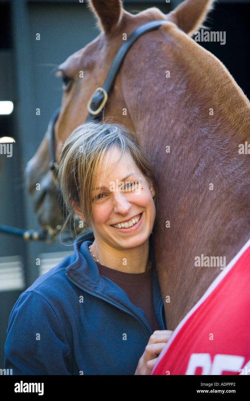 Woman in stable at horse show Stock Photo - Alamy