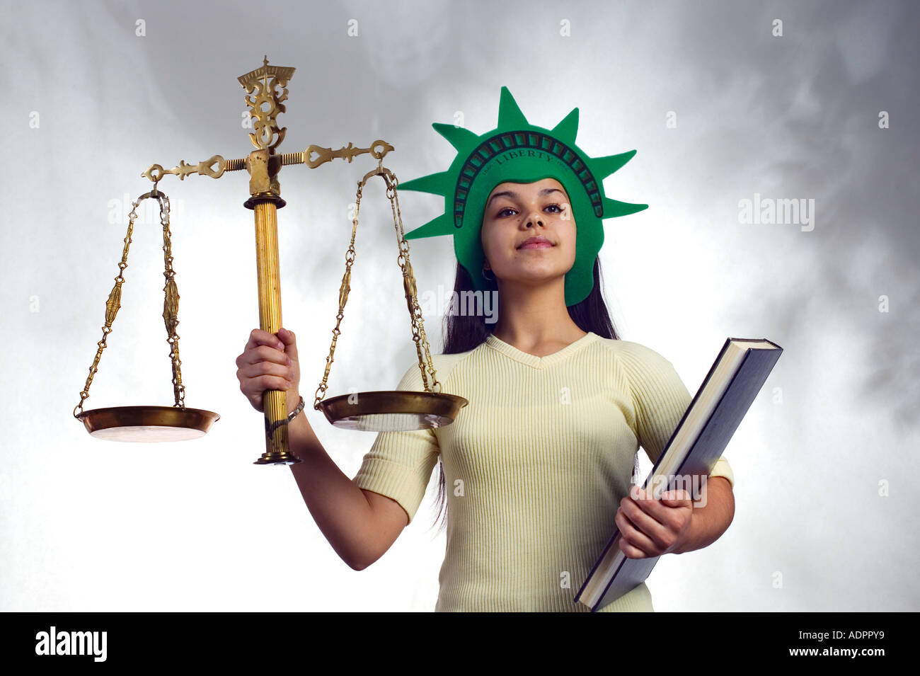 A girl poses dressed as the Statue of Liberty in a photography studio ...