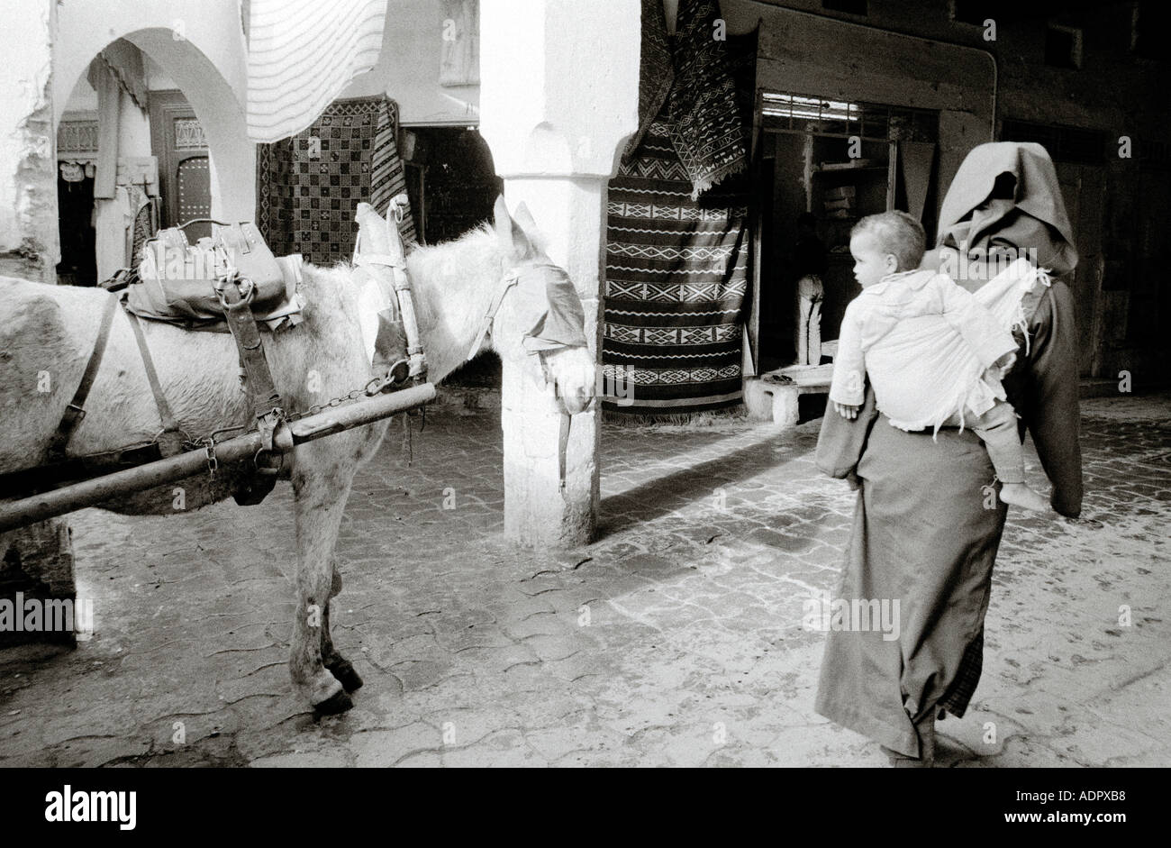 A Moroccan Muslim mother and child in the streets of the medina souk of ...