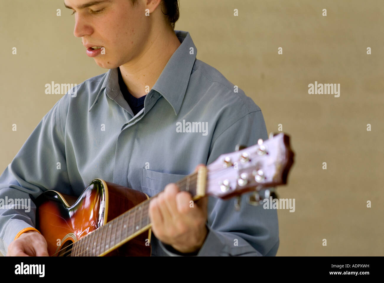 Teen playing an acoustic guitar Stock Photo - Alamy