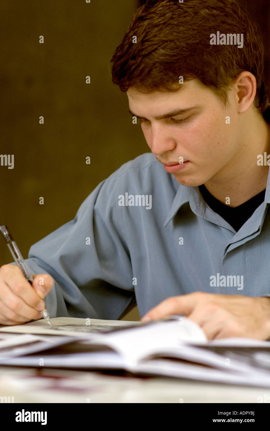 Young man drawing or sketching with books in front of him Stock Photo ...