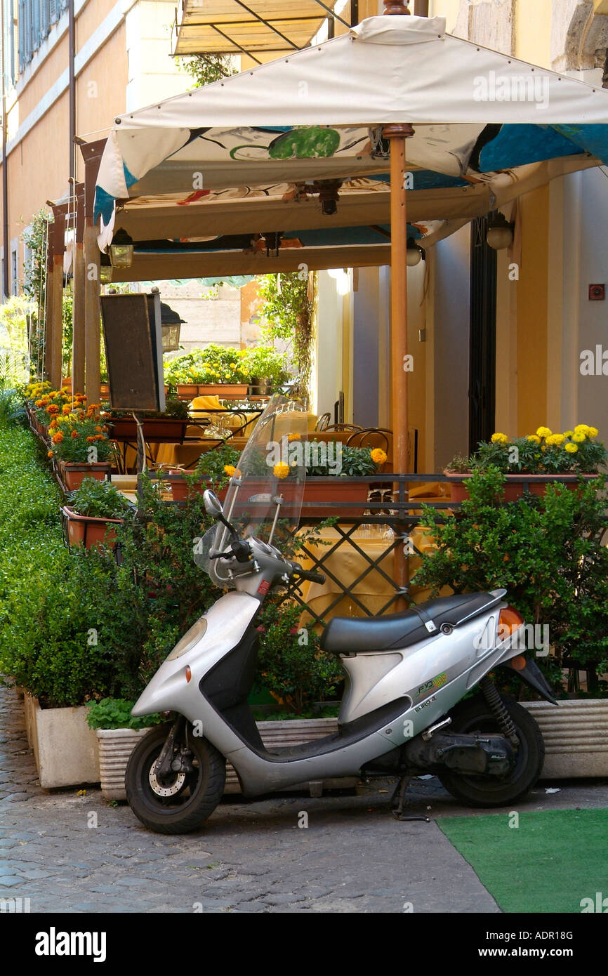 Scooter in front of an outdoor restaurant Stock Photo - Alamy