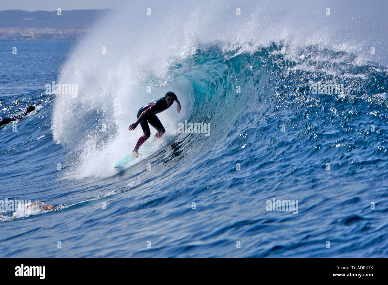 British Surfer, Tom Lowe drops into a nice wave at a surf spot called ...