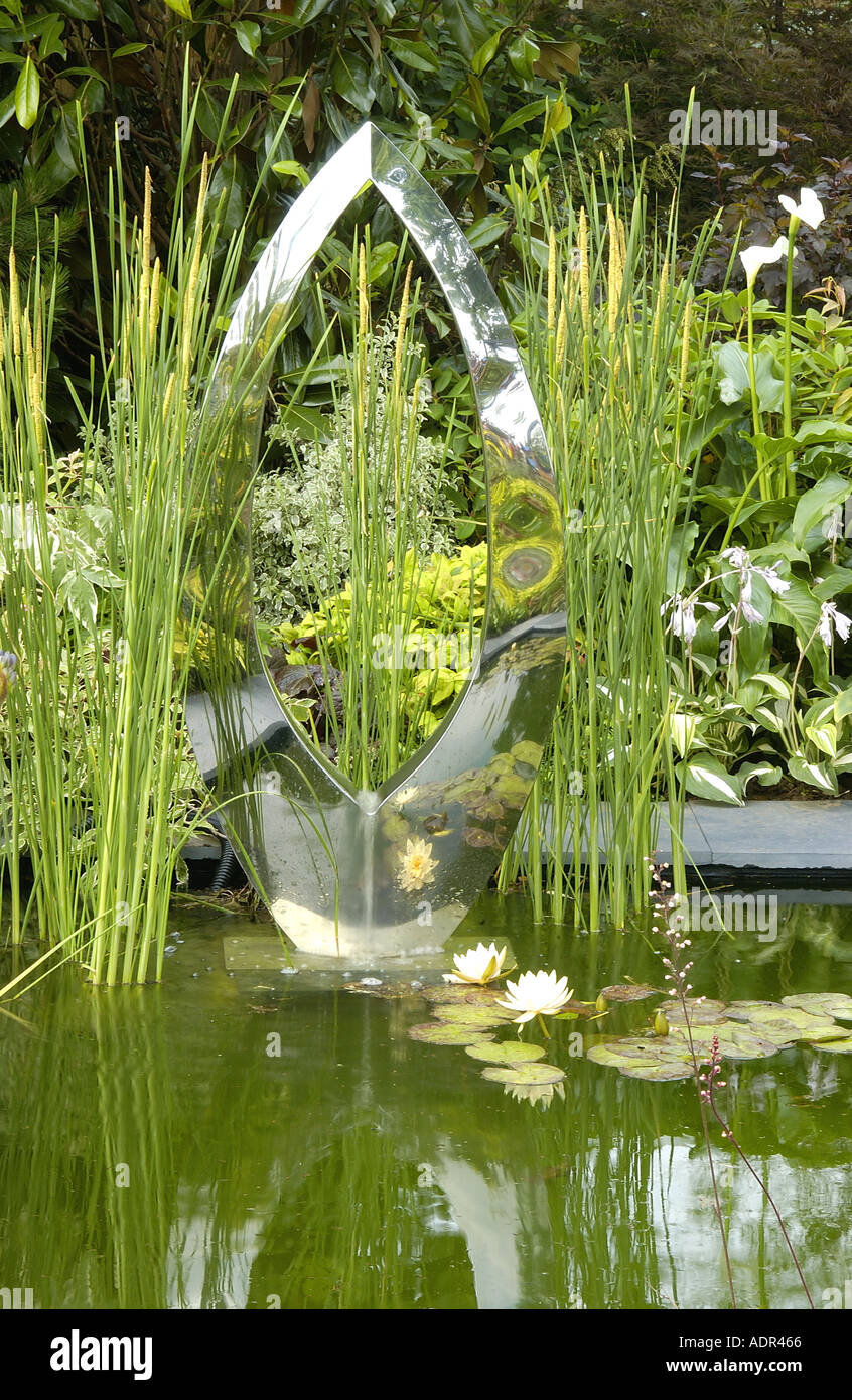 Garden pond and a reflective stainless steel arch Stock Photo - Alamy