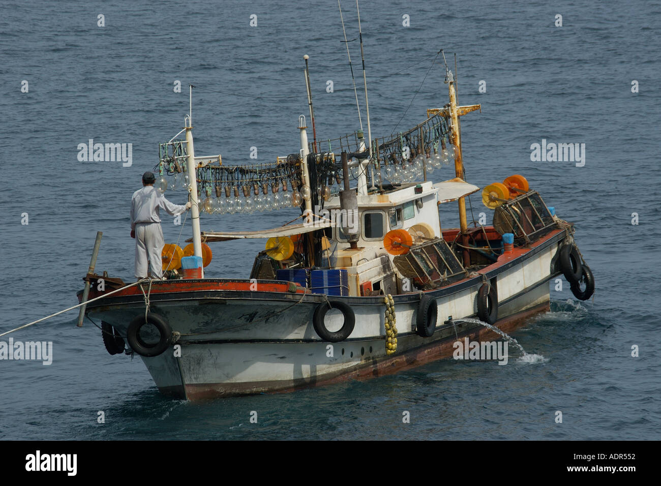 Fishing boat equiped with powerful lights used to attract squid at ...