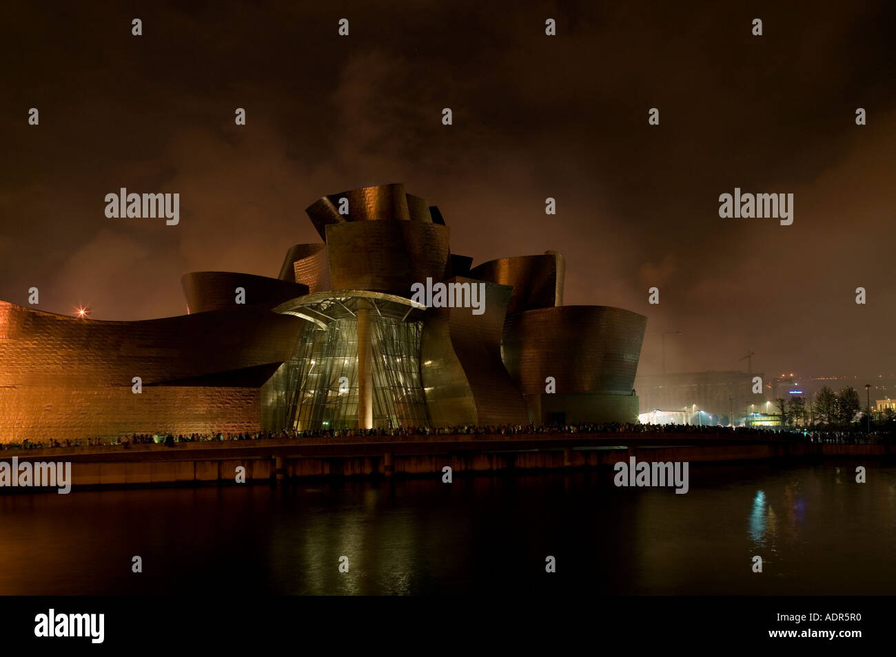 Guggenheim Museum Bilbao at night illuminated by the light of fireworks ...