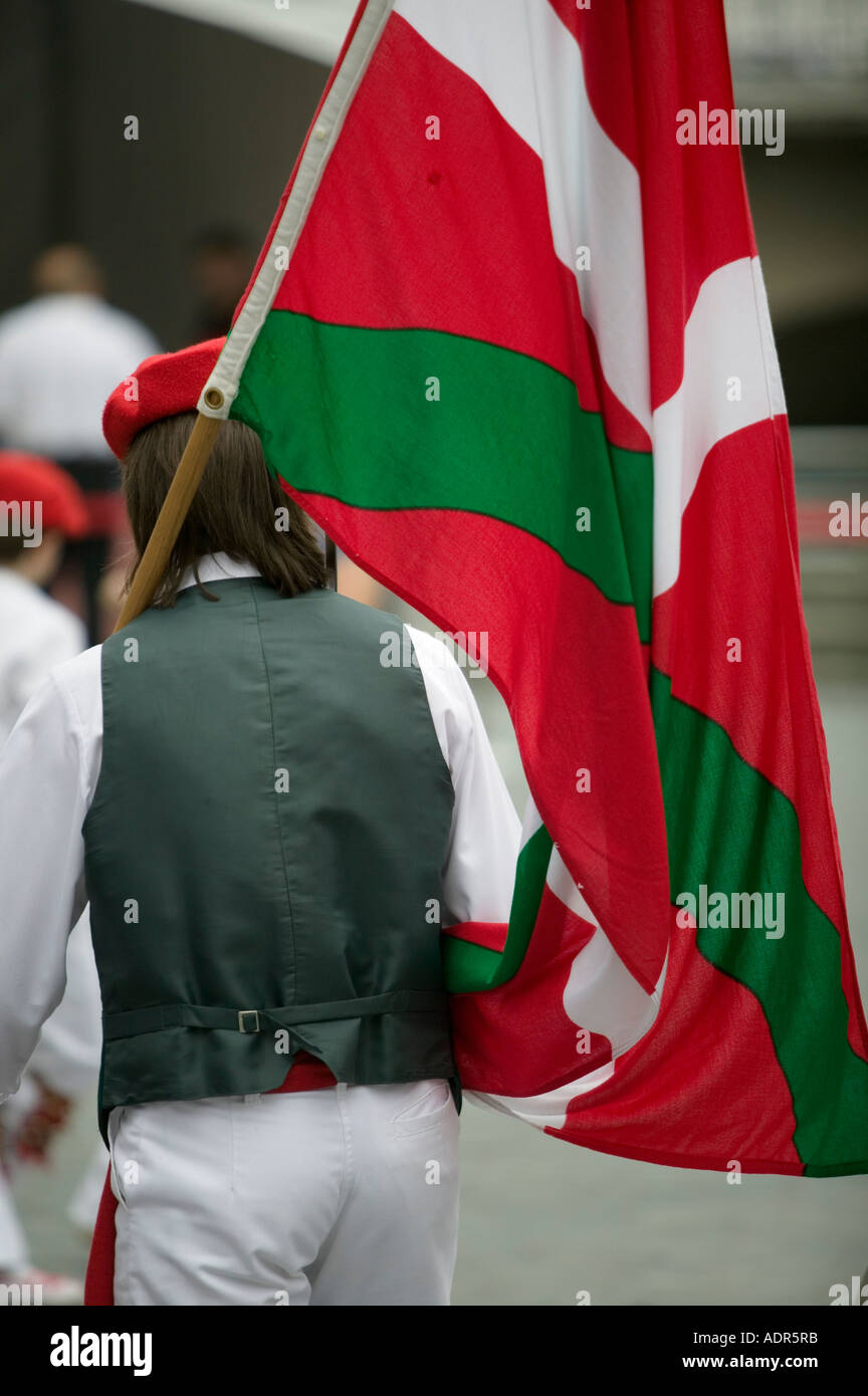 Young man holding the Basque national flag the Ikurrina during Basque ...