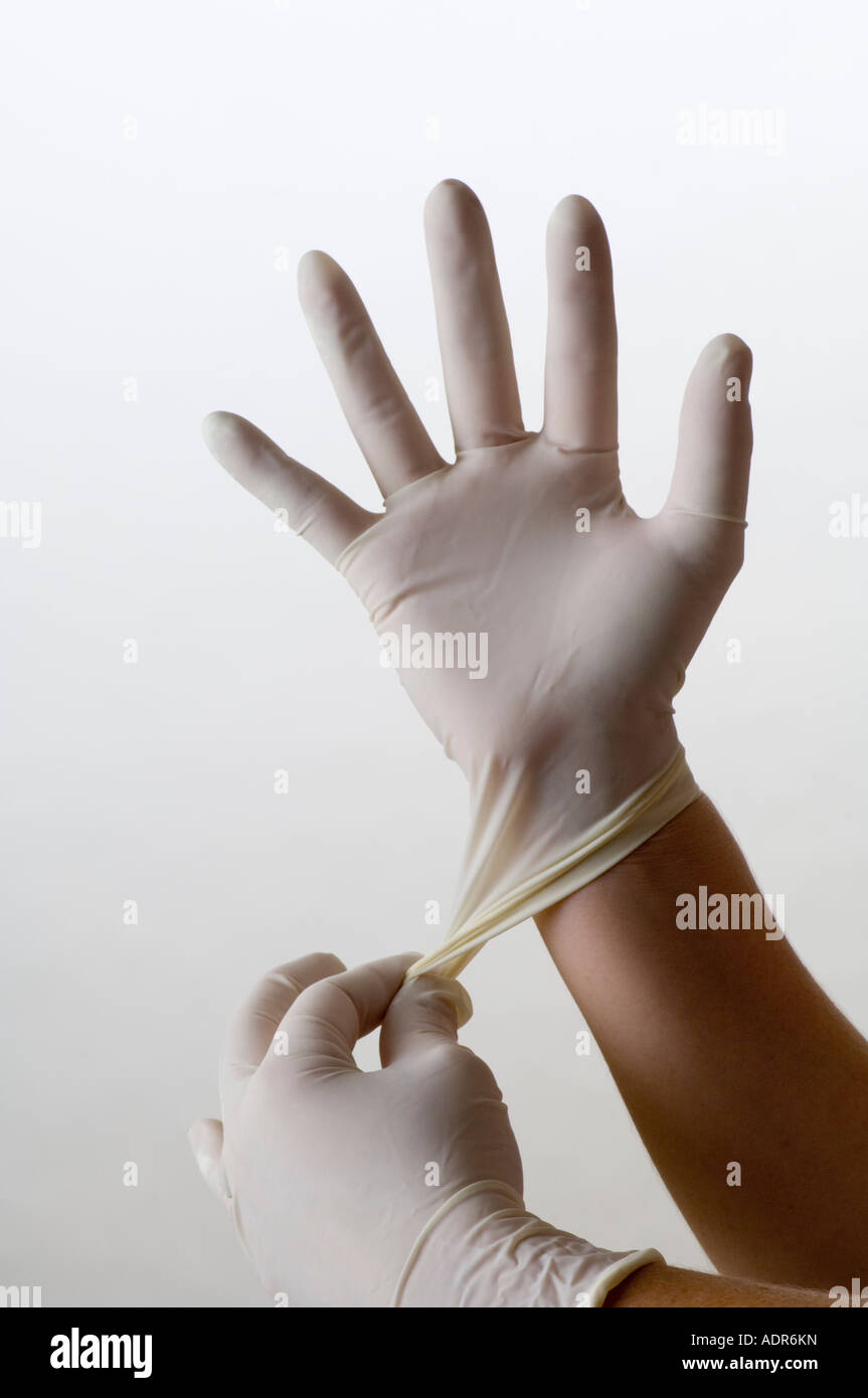 woman doctor putting on sterile latex gloves preparing for surgery ...