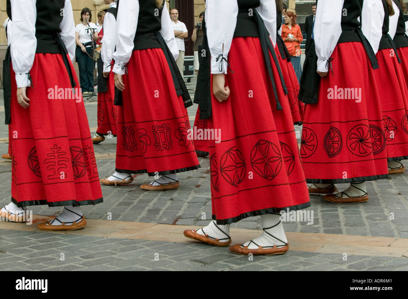 Red skirts of a group of young girls during a traditional Basque folk ...