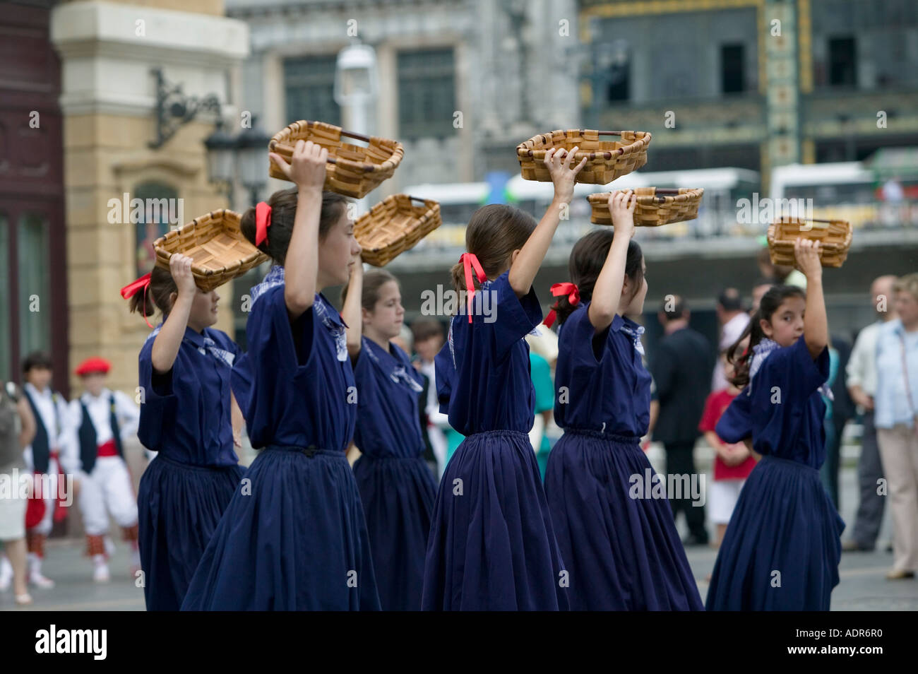 Young Basque girls dressed in blue perform a traditional Basque folk ...