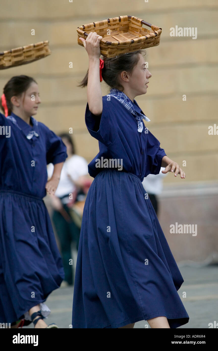 Young Basque girls dressed in blue perform a traditional Basque folk ...