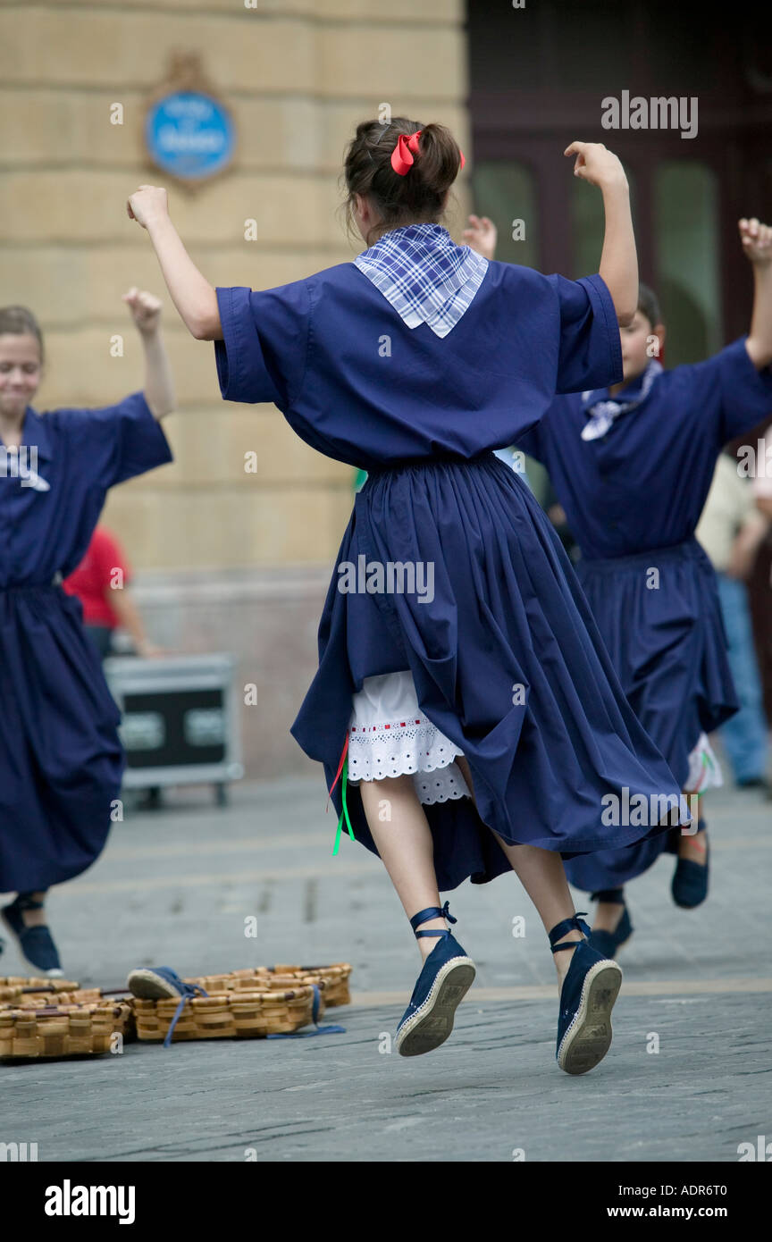 Young Basque girls dressed in blue perform a traditional Basque folk ...