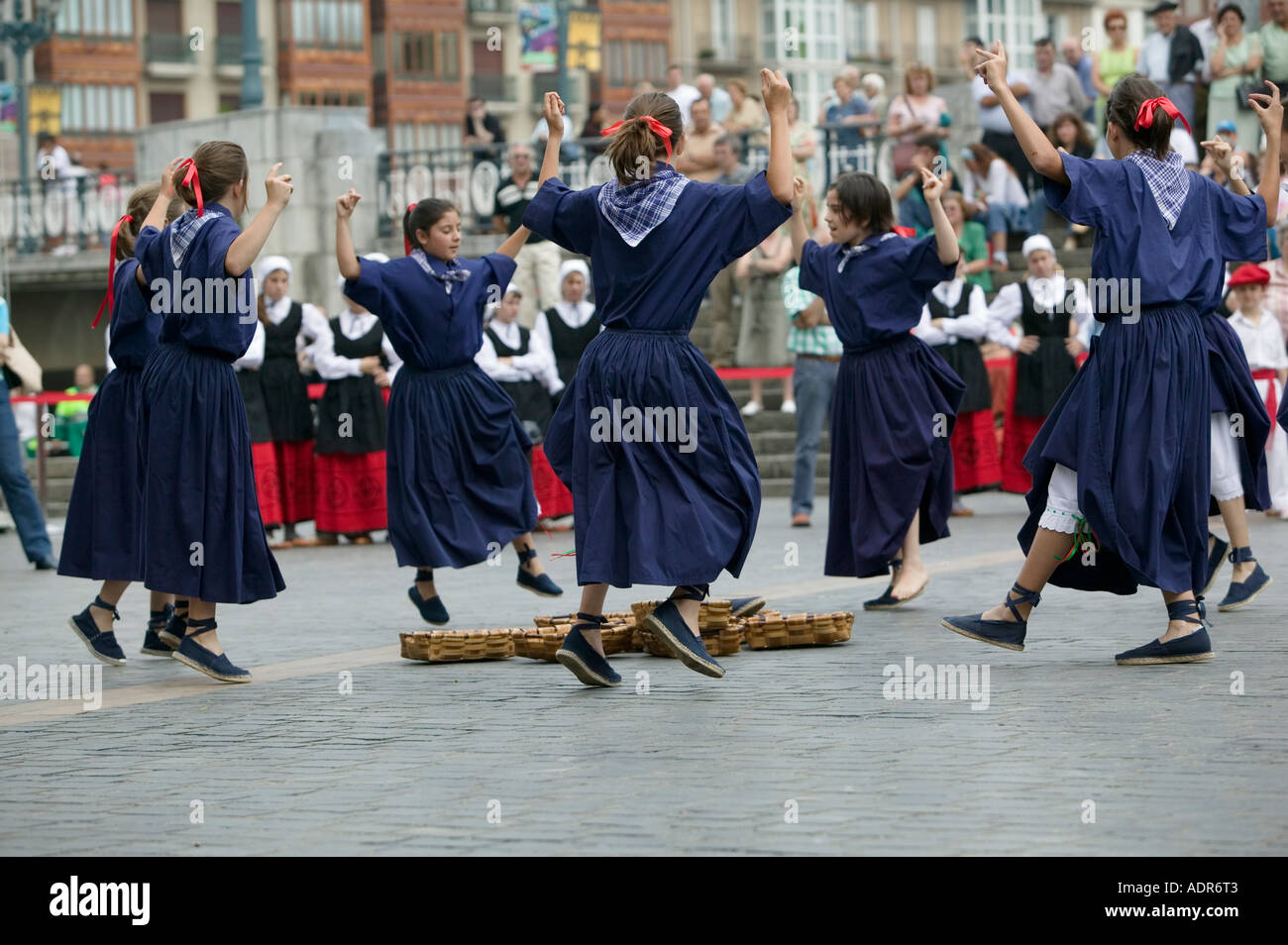 Young Basque girls dressed in blue perform a traditional Basque folk ...