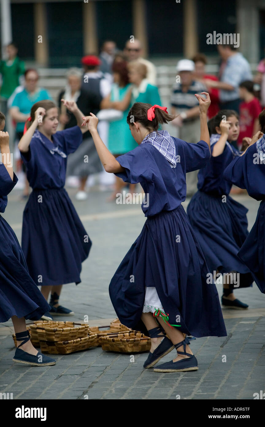 Young Basque girls dressed in blue perform a traditional Basque folk ...
