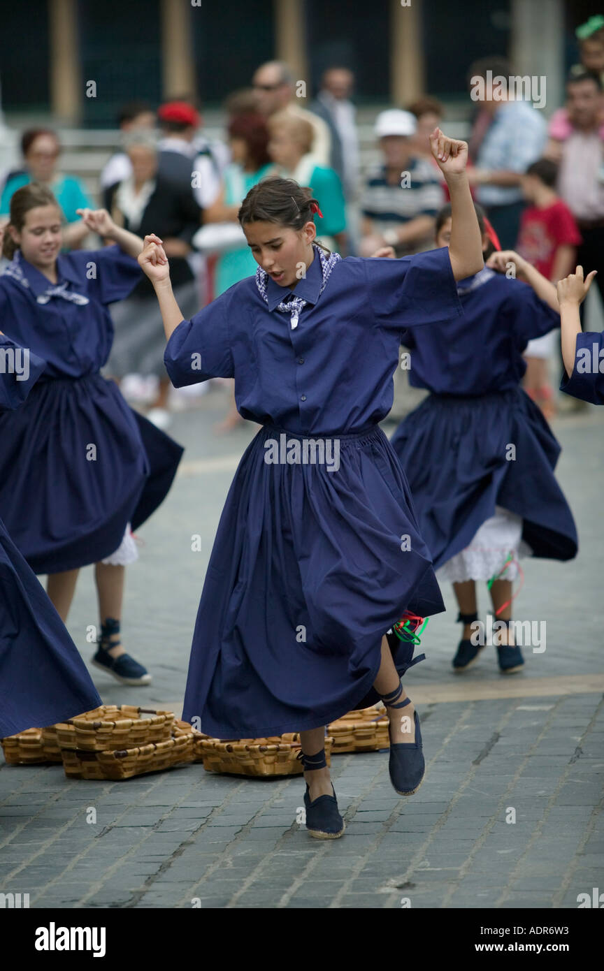 Young Basque girls dressed in blue perform a traditional Basque folk ...