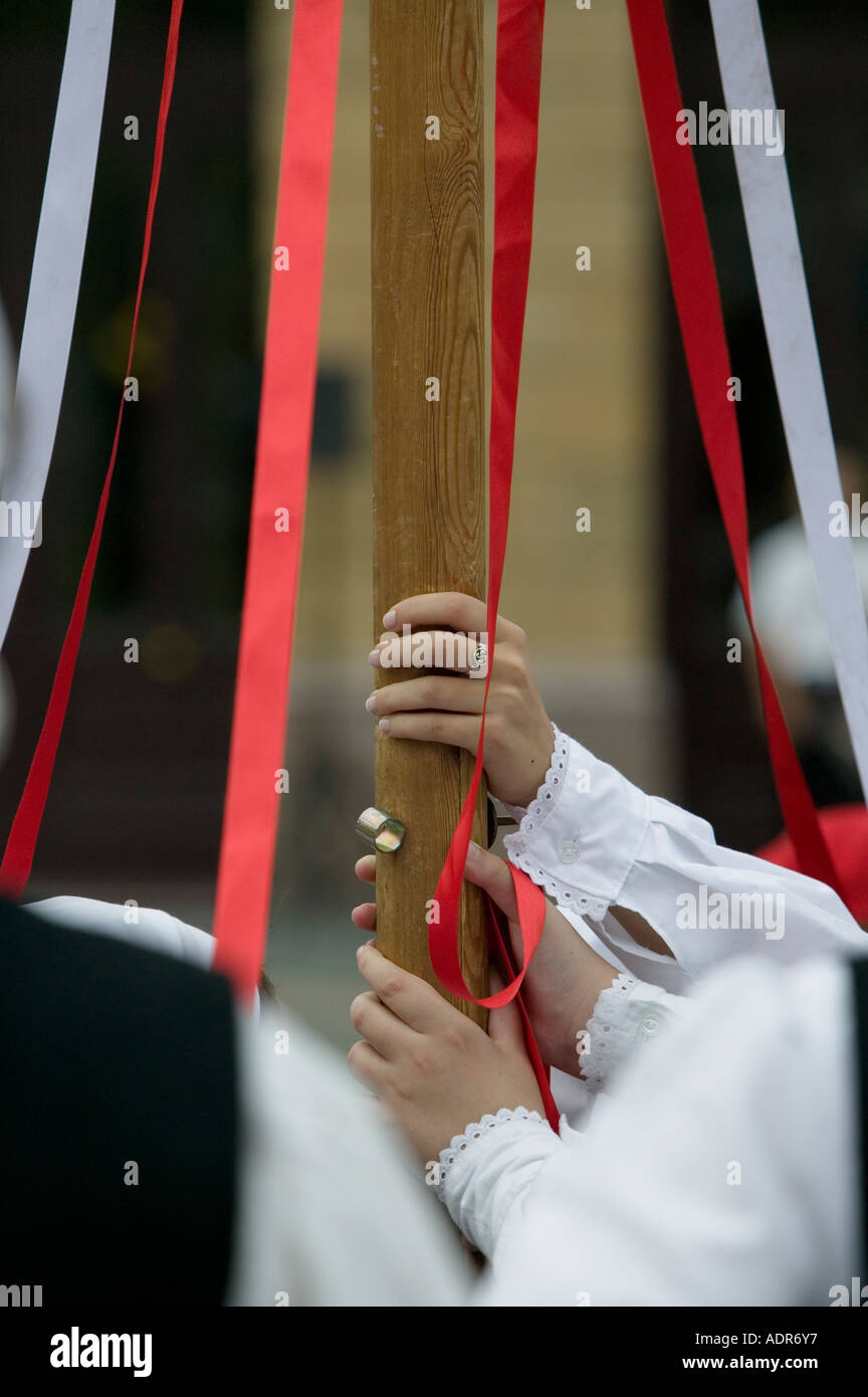 Hands of young Basque people holding a May Pole during Basque folk ...