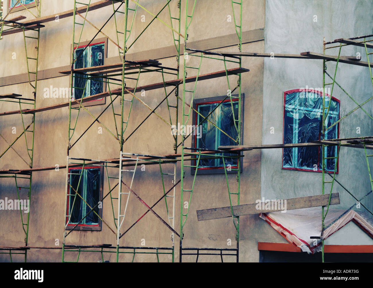 a scaffold goes up around condos being built Stock Photo - Alamy