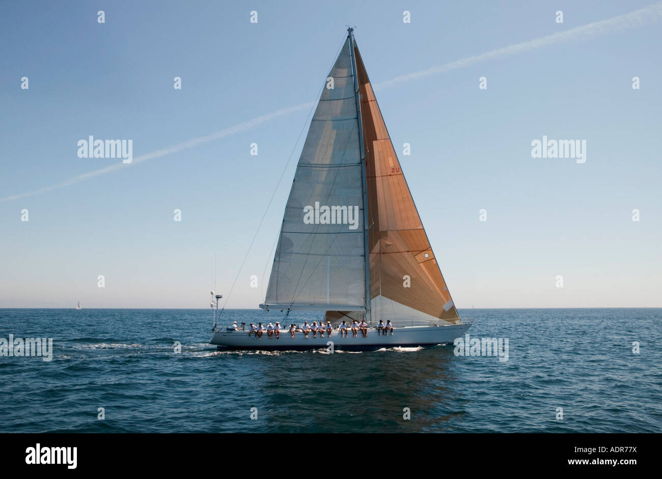 Crew sitting on side of sailboat, side view Stock Photo - Alamy