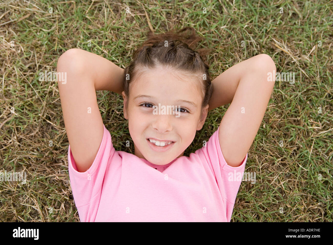 Girl lying on grass Stock Photo - Alamy