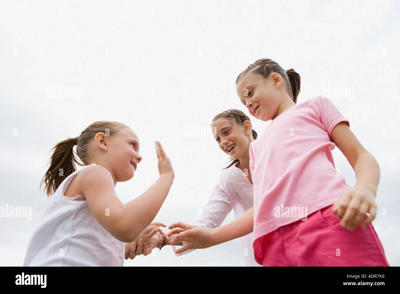 Three girls playing Stock Photo - Alamy