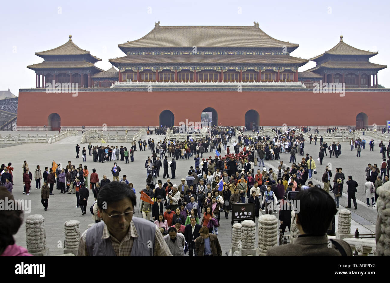 CHINA BEIJING Crowds of Chinese tourists follow their tour guides flags ...