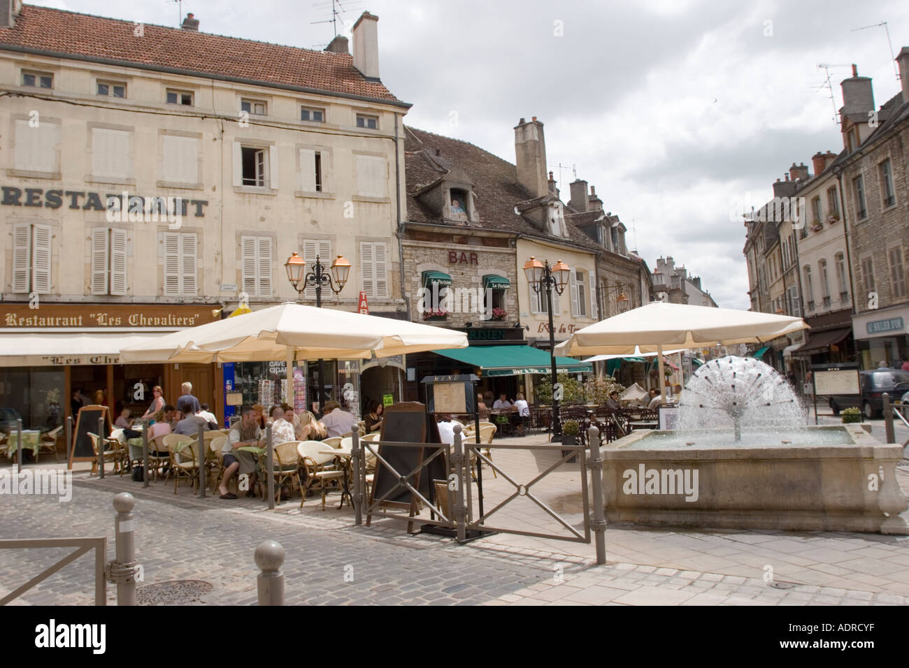 Water feature, Old buildings cafes and shops in Beaune Bourgogne France ...