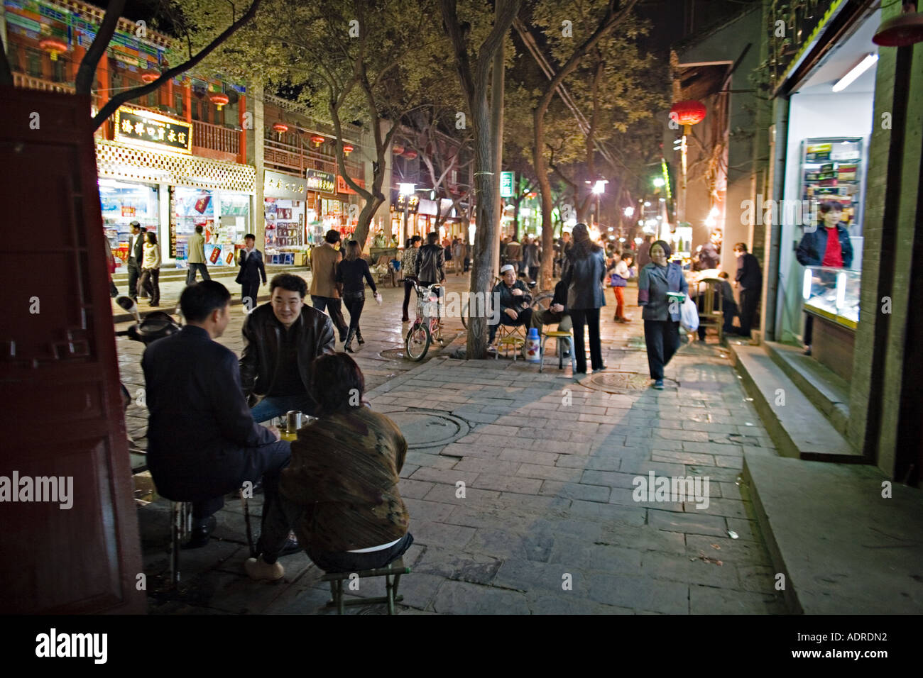 CHINA XI'AN Night scene of a busy street in the Muslim Quarter of old ...
