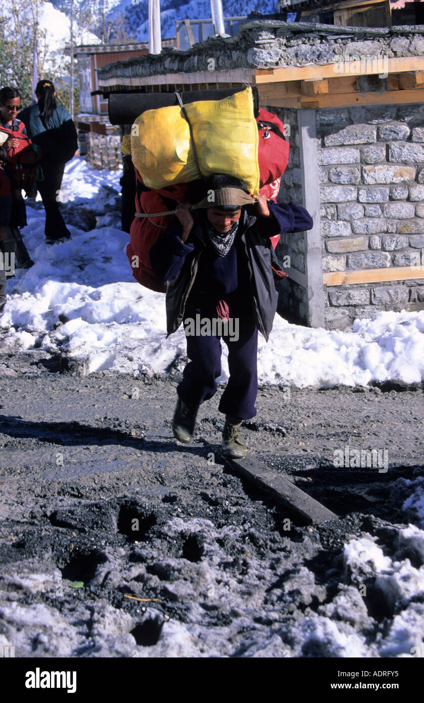 Nepali porter carrying goods in Braga village in Annapurna Conservation ...