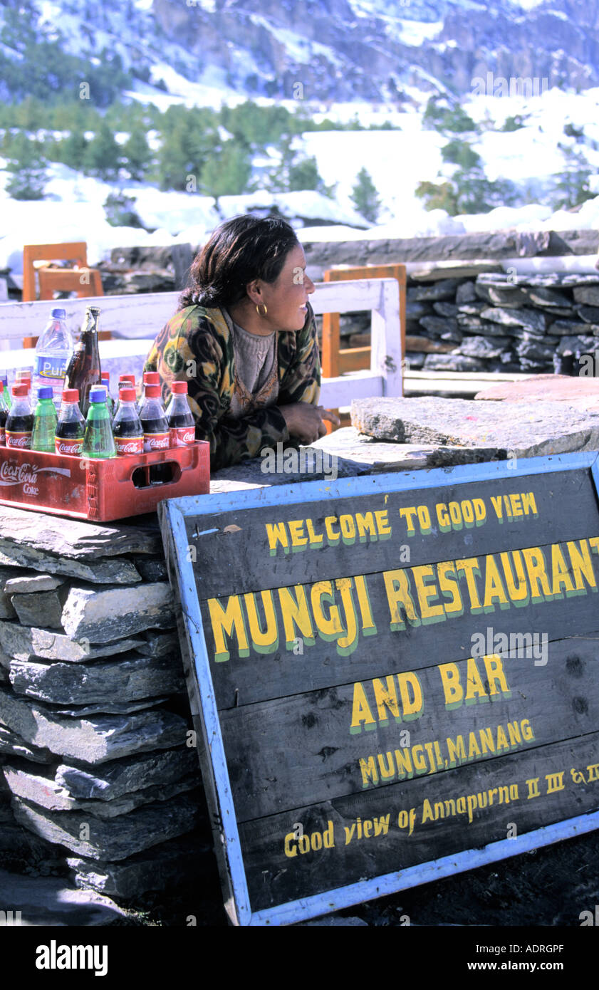Nepali woman selling soft drinks at local restaurant near Mungji Manang ...