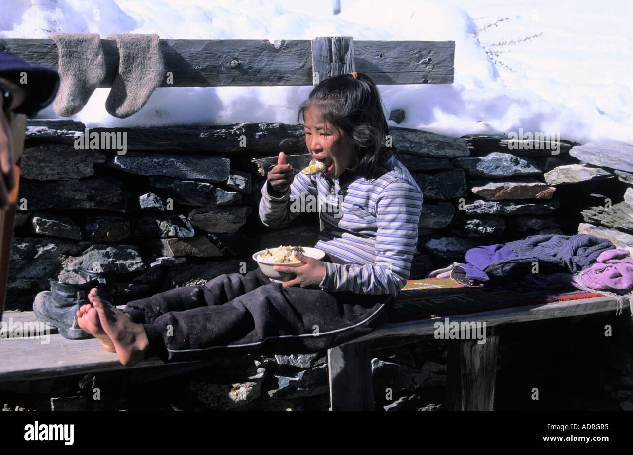 Nepali girl enjoys lunch at local restaurant near Mungji Manang village ...