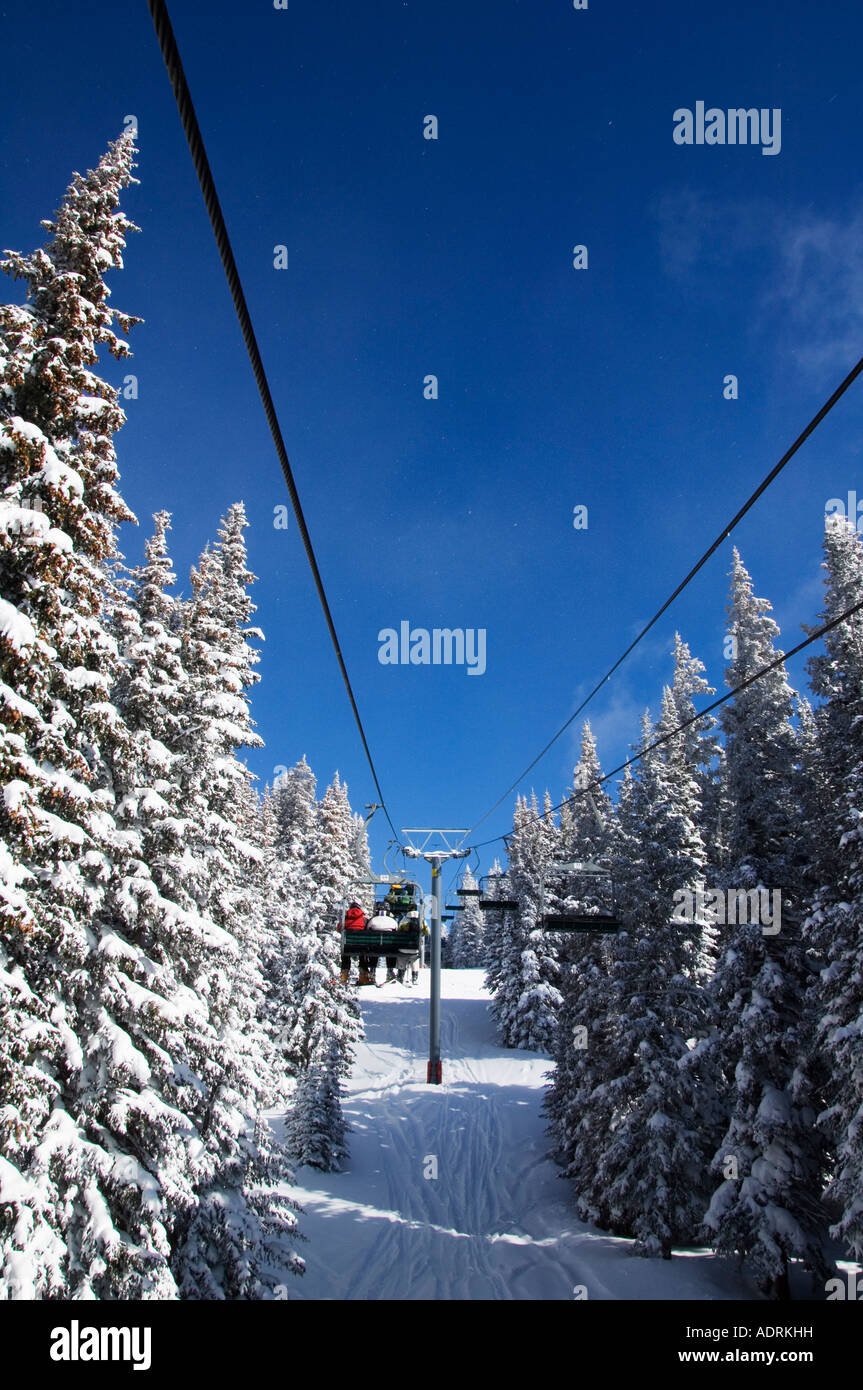 USA Colorado Vail Ski Resort Skiers being carried on a chair lift in ...