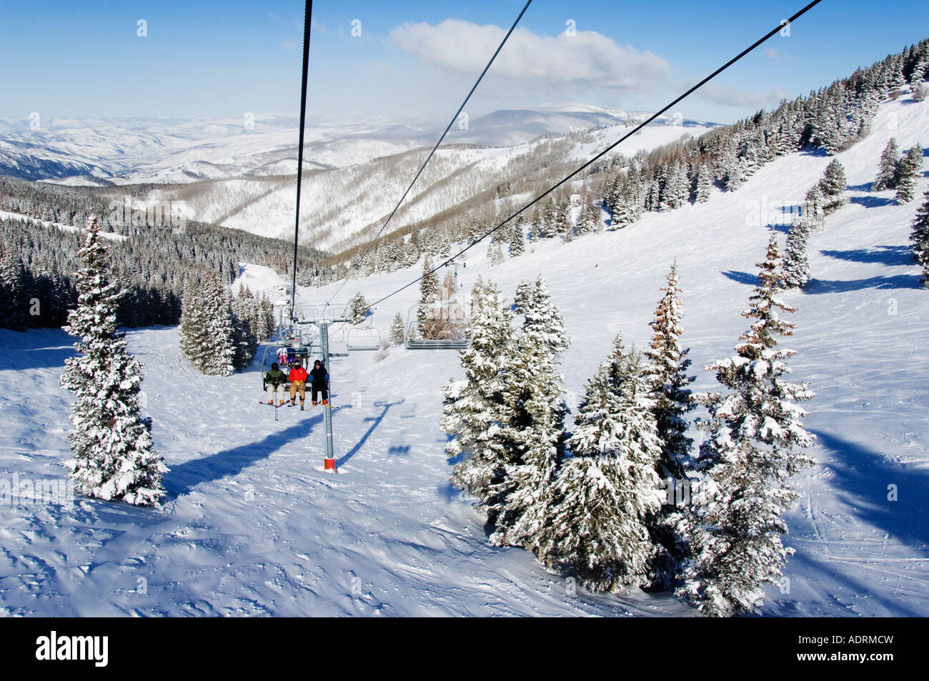 USA Colorado Vail Ski Resort Skiers being carried on a chair lift in ...