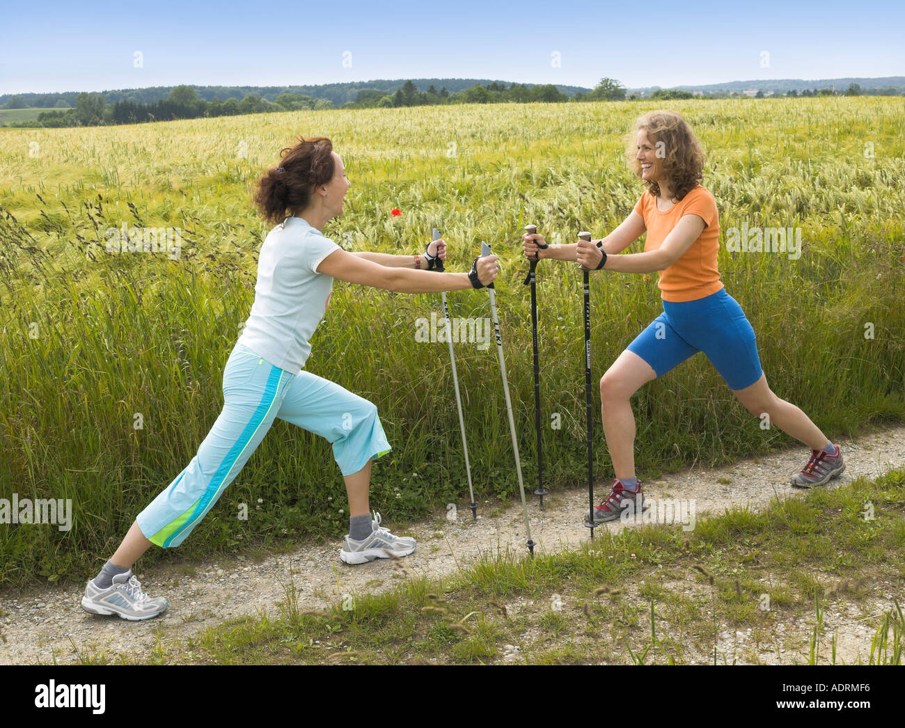 2 two women warm up for Nordic Walking with stretching exercises Stock ...