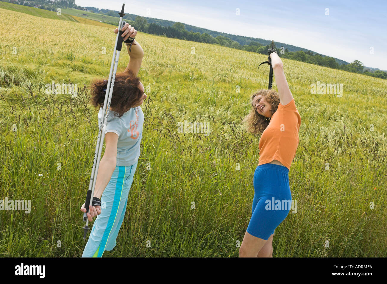 2 two women warm up for Nordic Walking with stretching exercises Stock ...