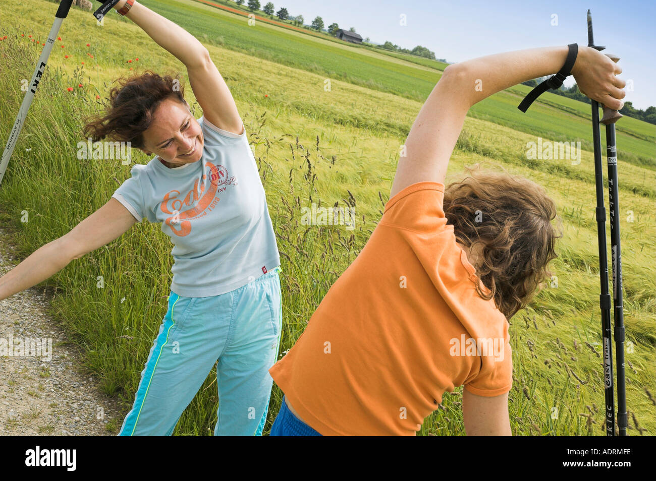 2 two women warm up for Nordic Walking with stretching exercises Stock ...