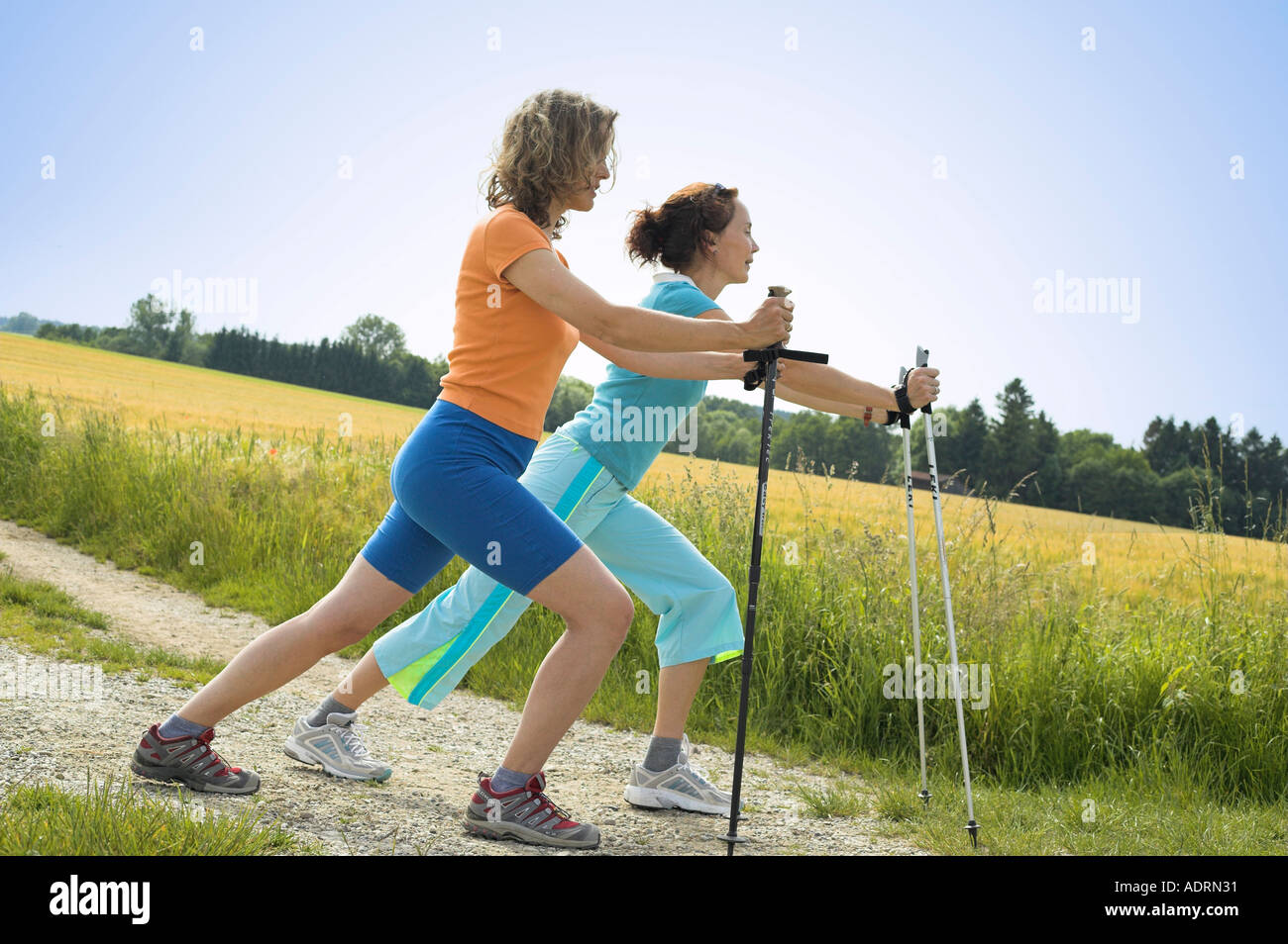 2 two women warm up for Nordic Walking with stretching exercises Stock ...
