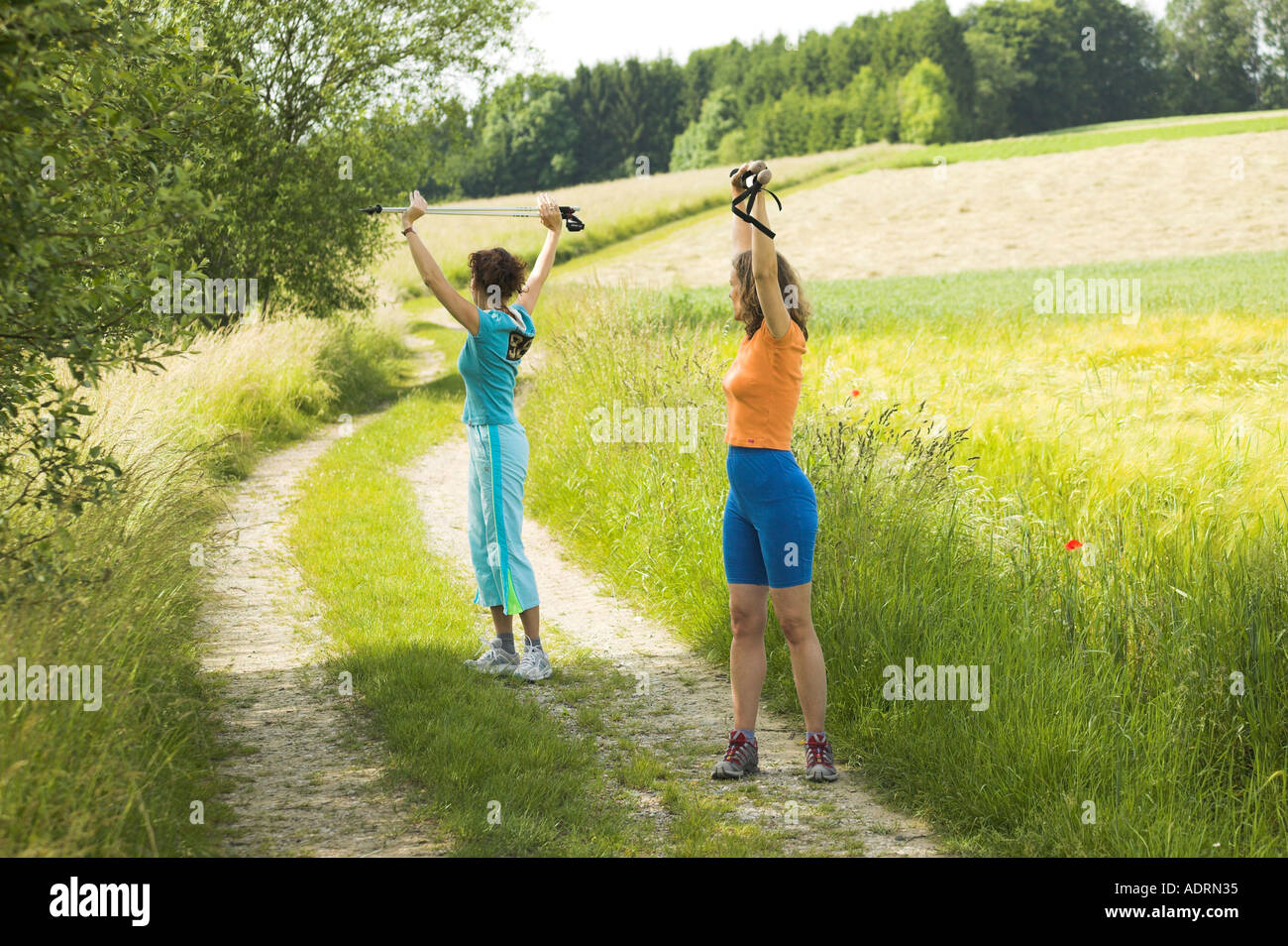 2 two women warm up for Nordic Walking with stretching exercises Stock ...