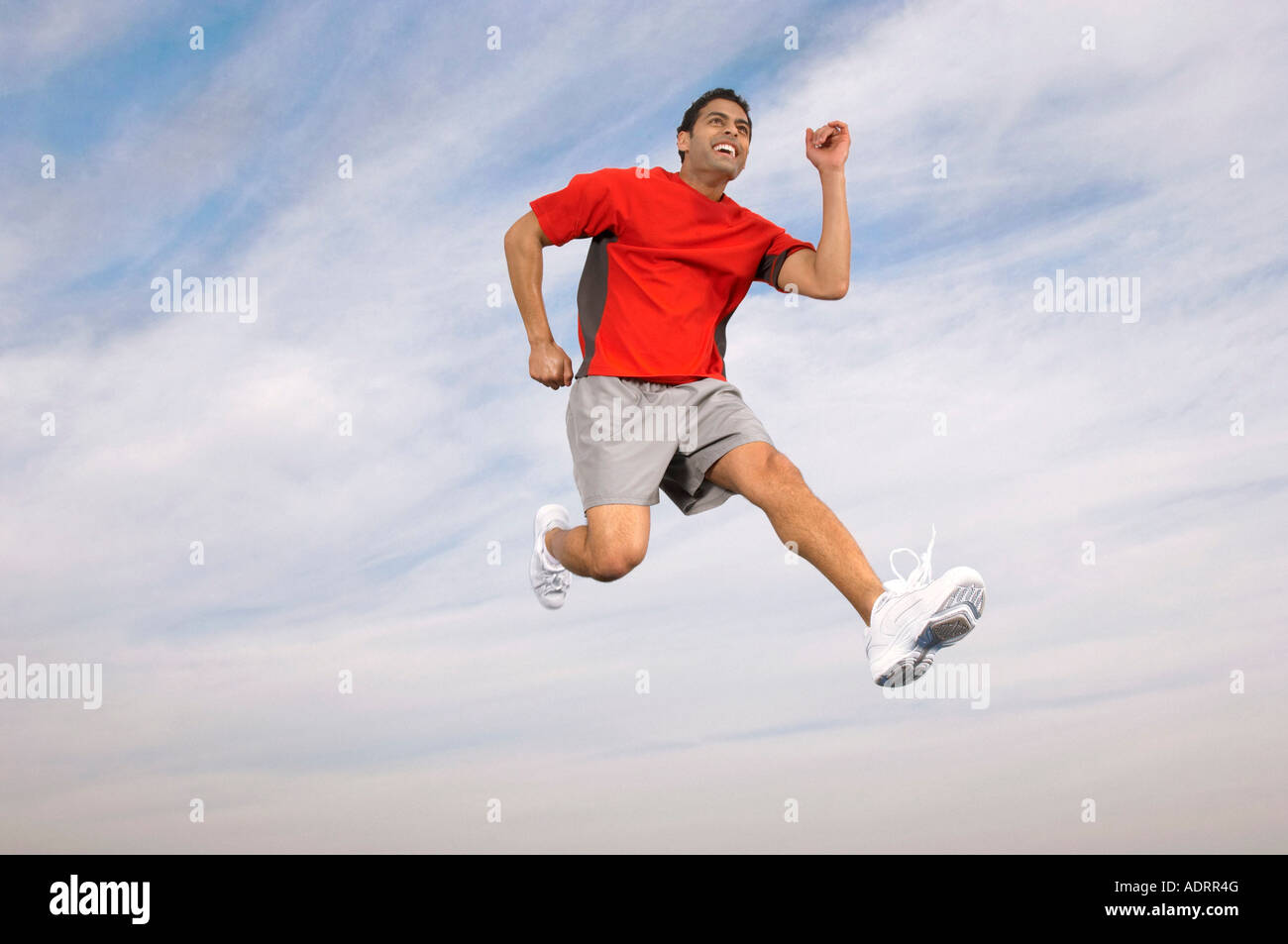 Athlete running mid-air Stock Photo - Alamy